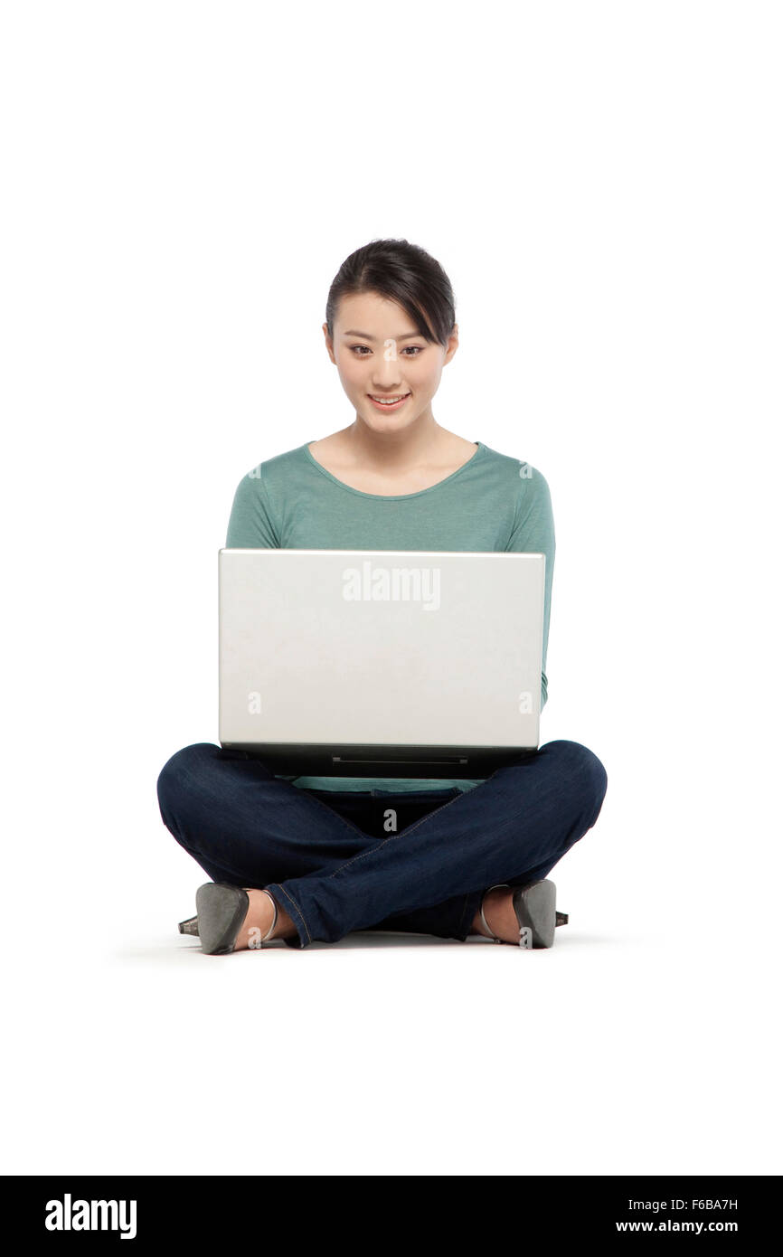 Young woman using a laptop computer Stock Photo - Alamy