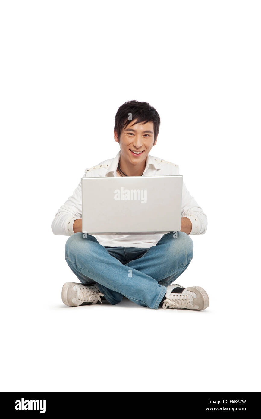 Young man using a laptop computer Stock Photo - Alamy