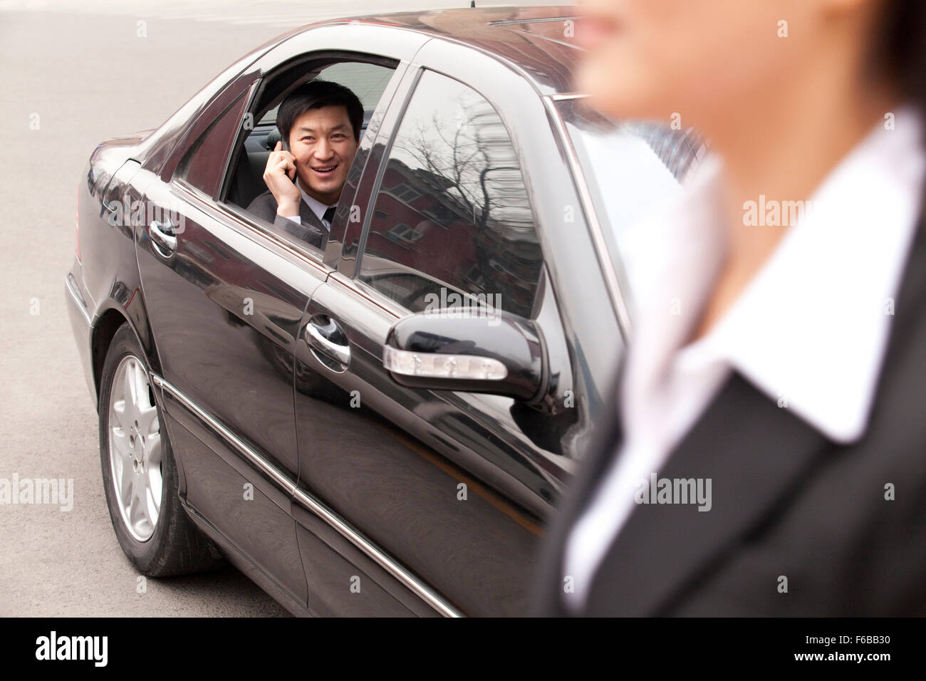 Businessman on phone looking out window Stock Photo - Alamy