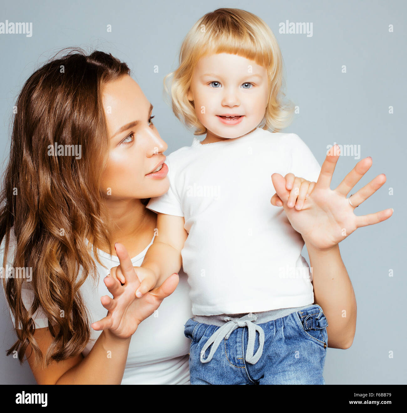 pretty real fashion mother with cute blond little daughter close up ...