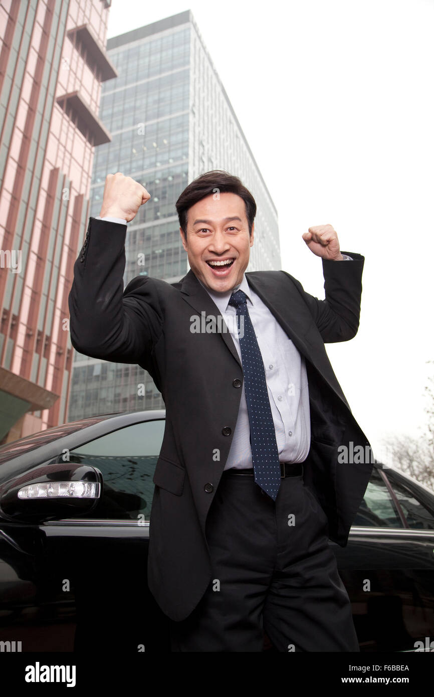 Businessman expressing enthusiasm Stock Photo - Alamy