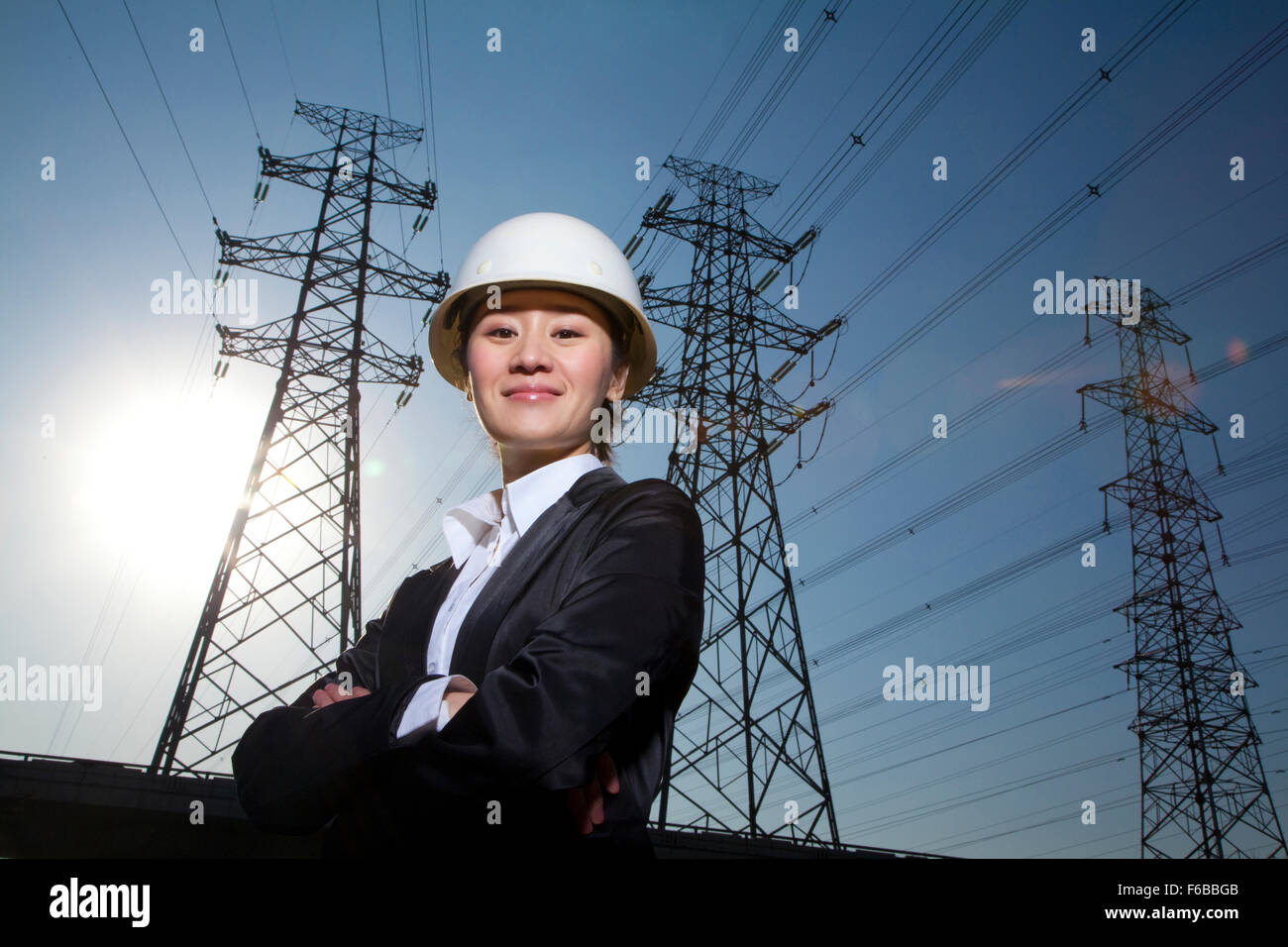 Businesswoman in front of power lines Stock Photo - Alamy