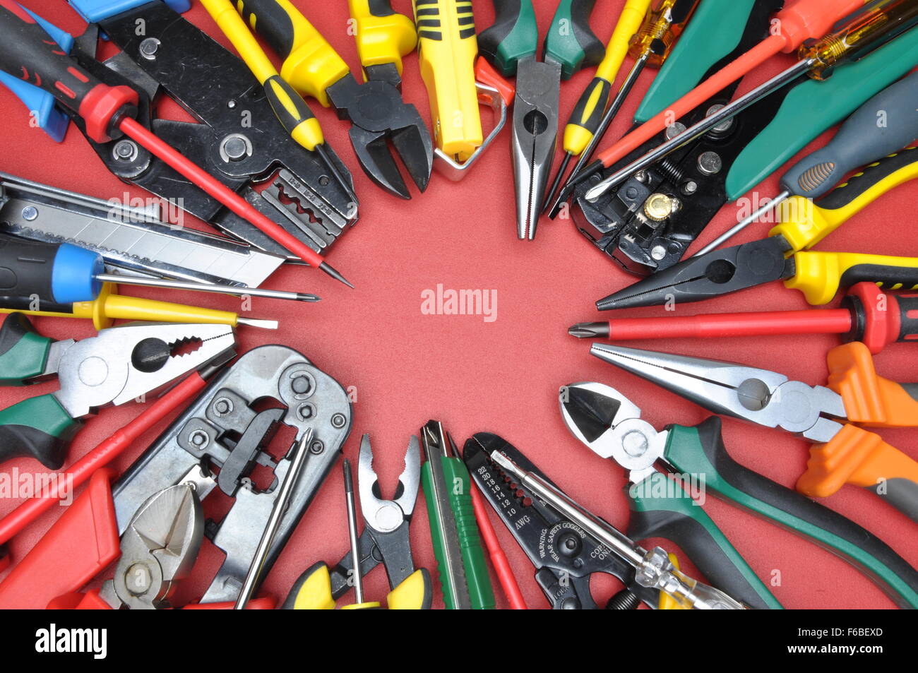 Tools for electrical installation on red metal surface with place on ...