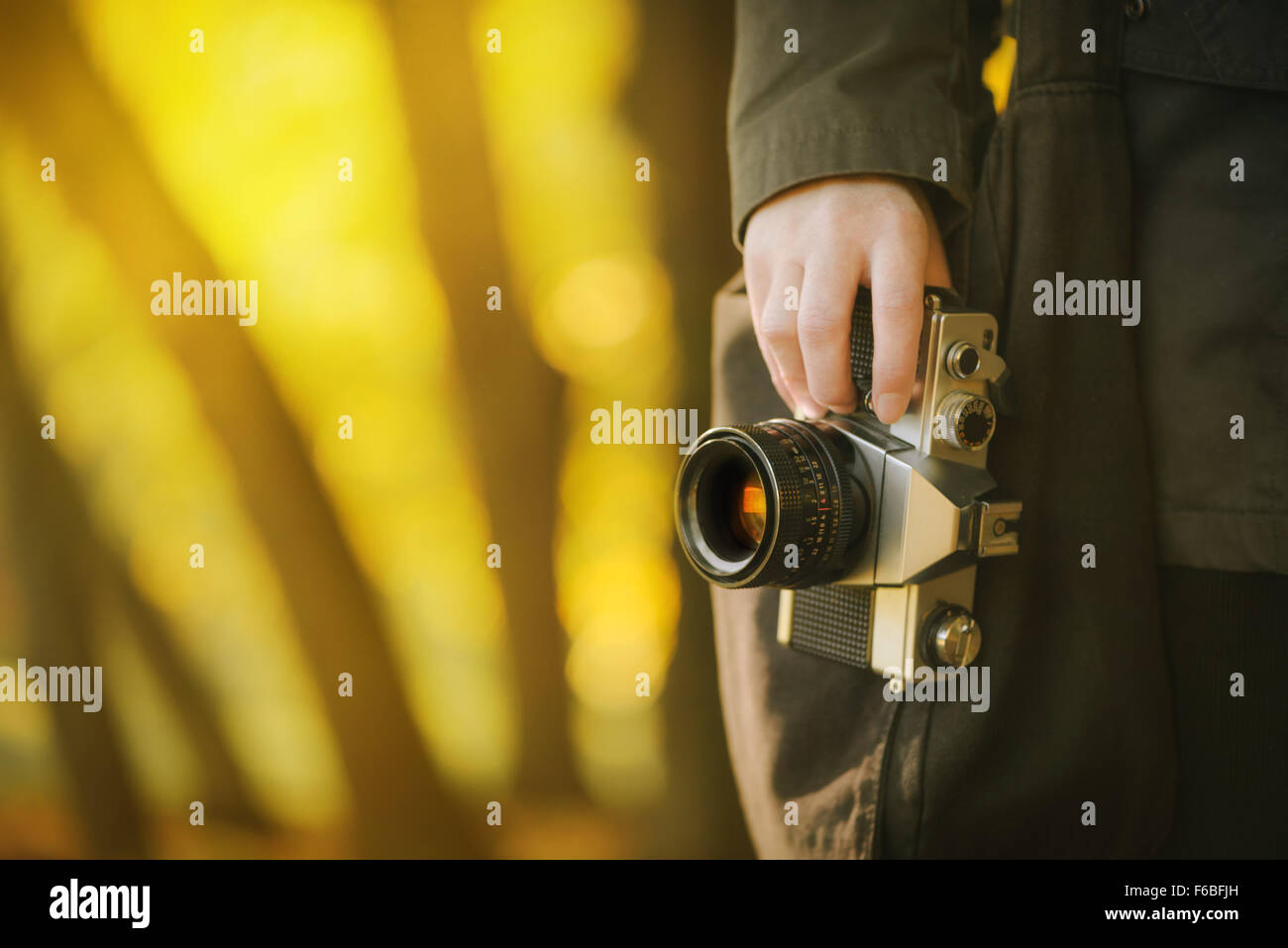 Hipster photographer exploring nature autumn scenery with old vintage ...