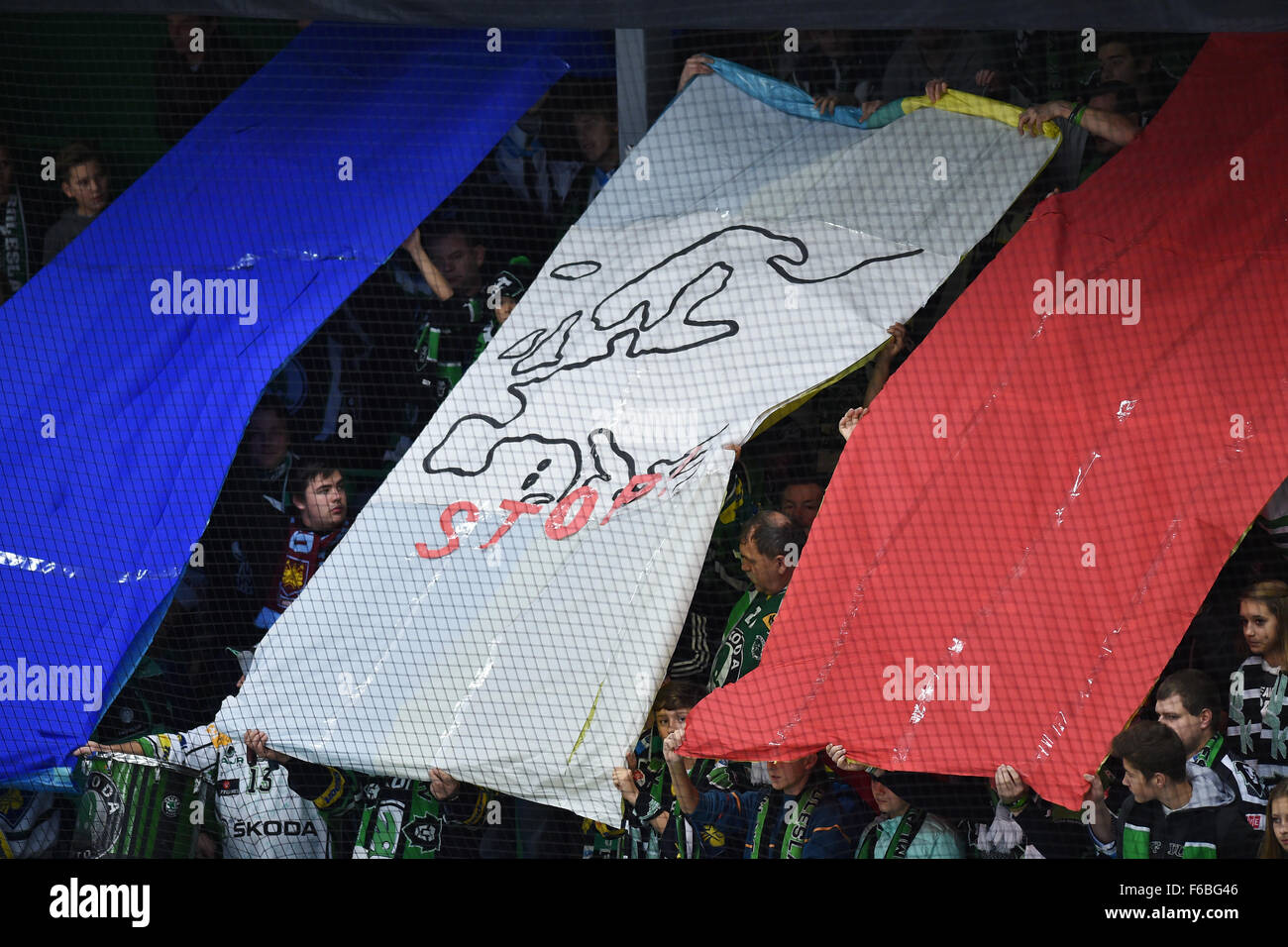 Fans hold flags in the colors of the French tricolor during a minute of ...