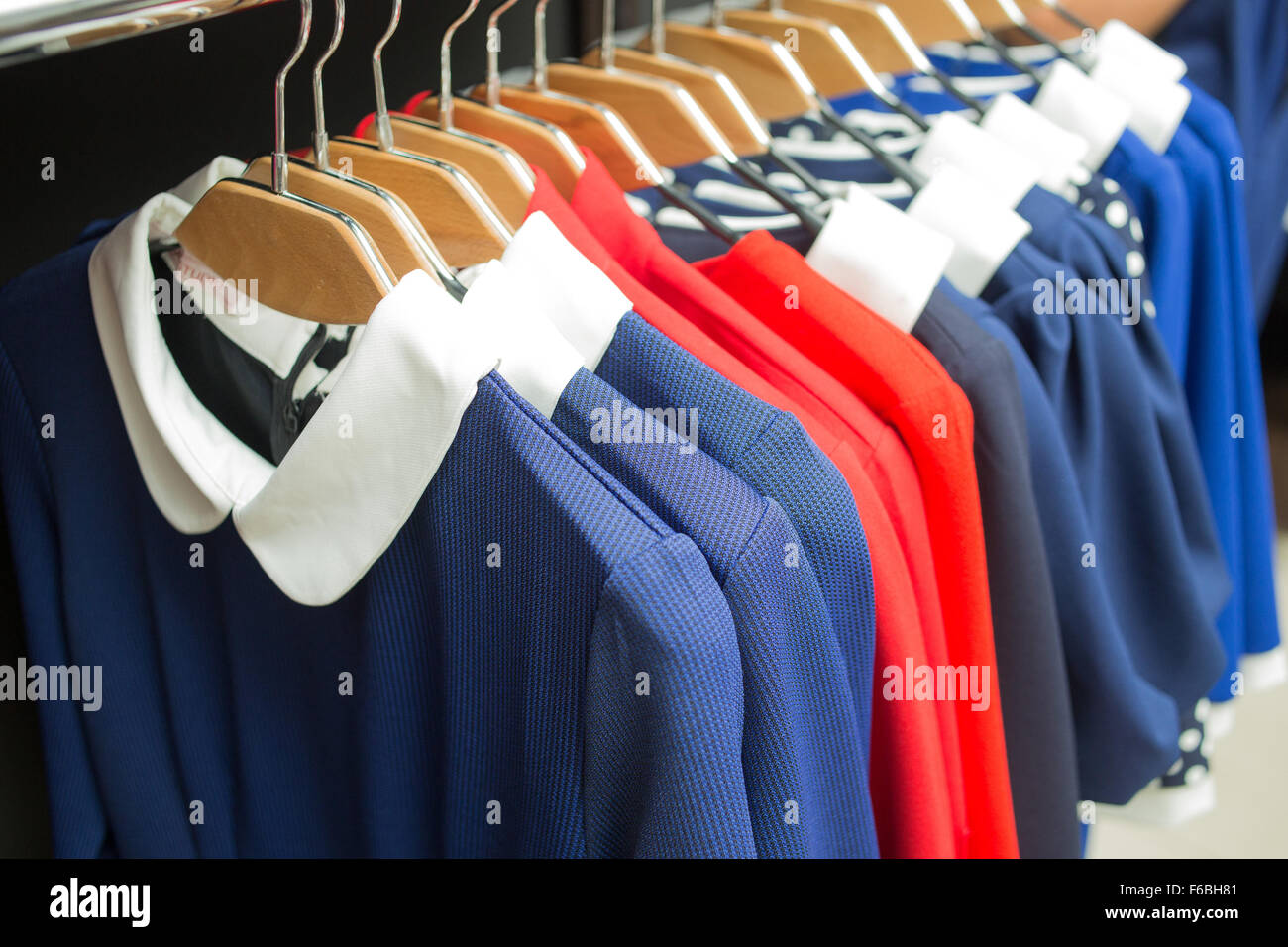 Floral design summer blue dresses on store rack Stock Photo - Alamy