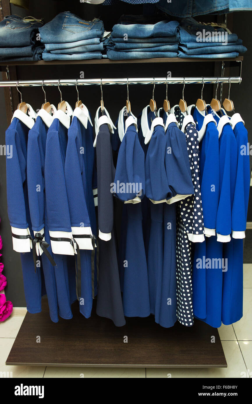 Floral design summer blue dresses on store rack Stock Photo - Alamy