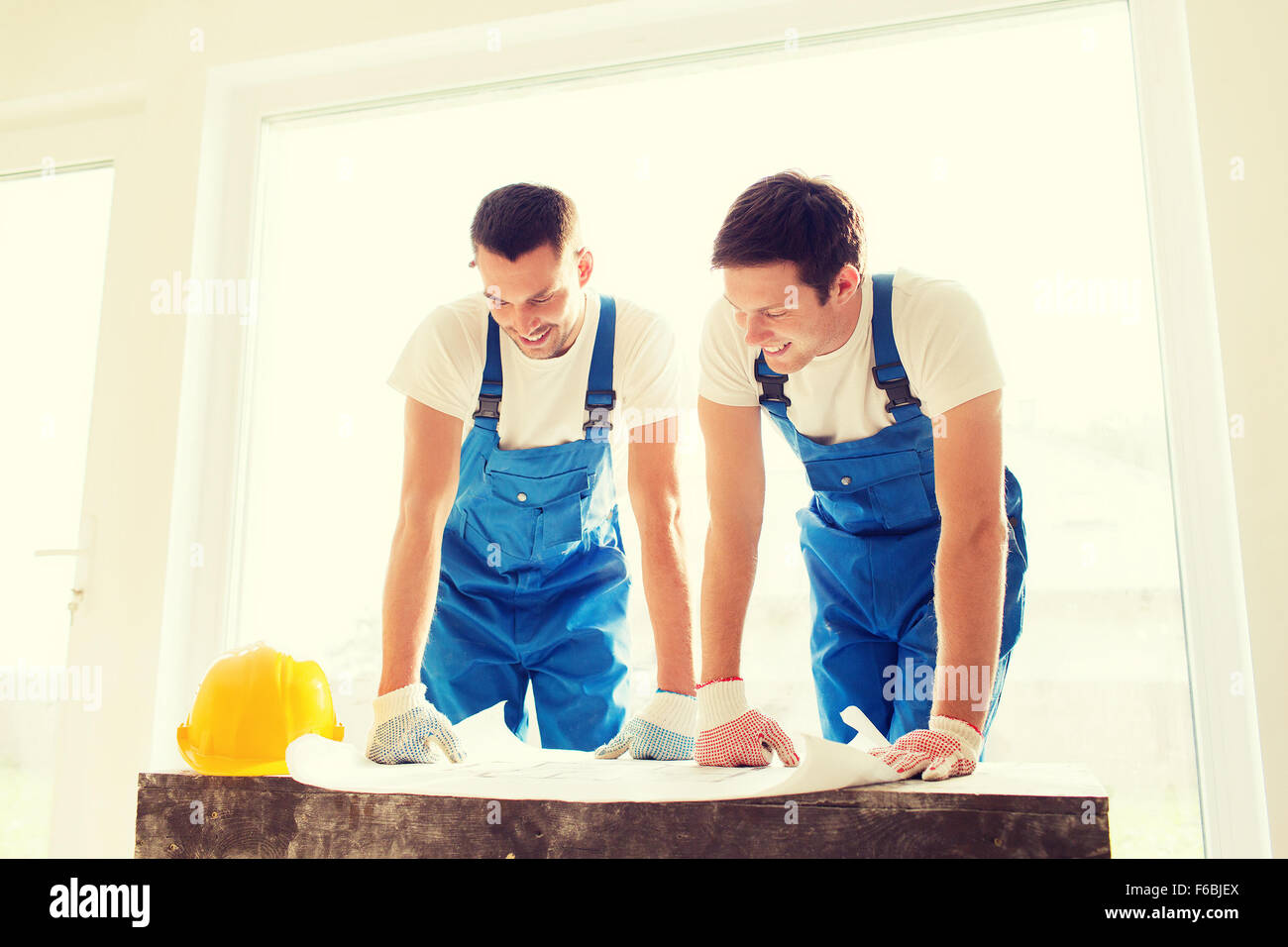 group of builders with blueprint Stock Photo - Alamy