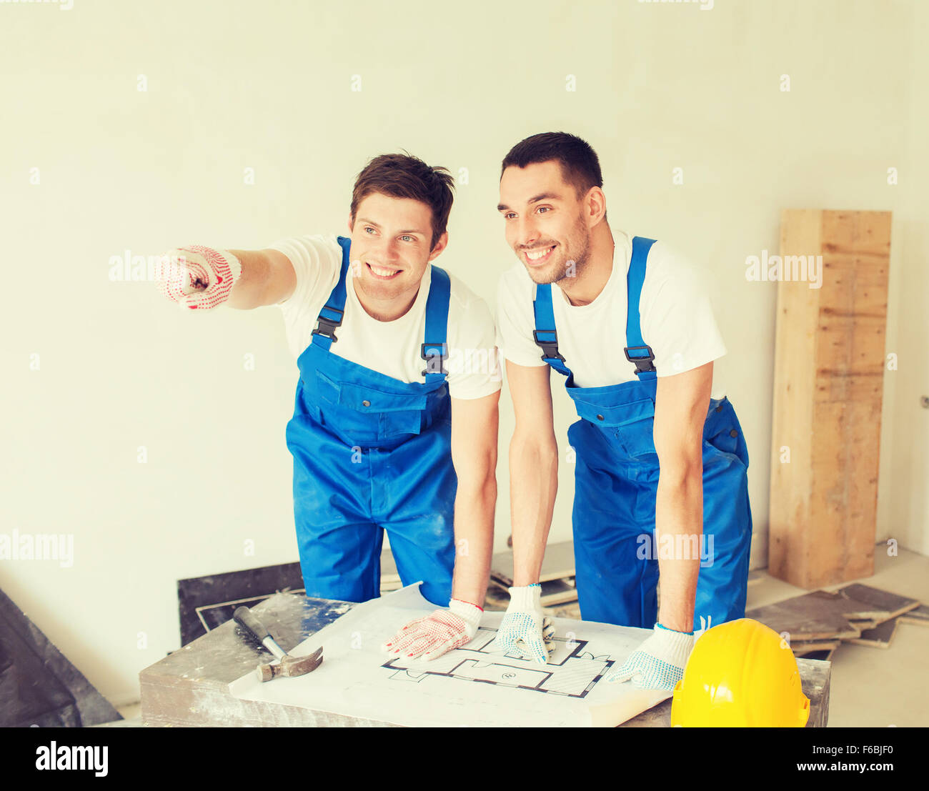 group of builders with blueprint Stock Photo - Alamy