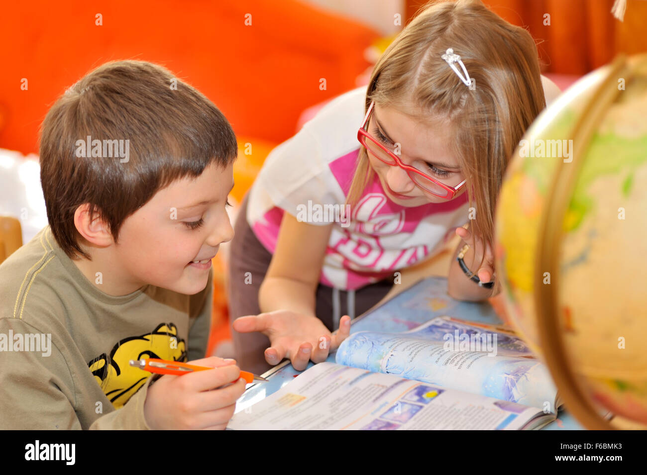 Couple of kids doing some homework Stock Photo - Alamy
