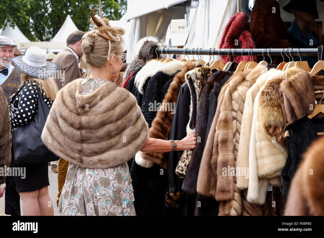 A woman browses a fur stall at the Goodwood Revival on 13/09/2015 at ...