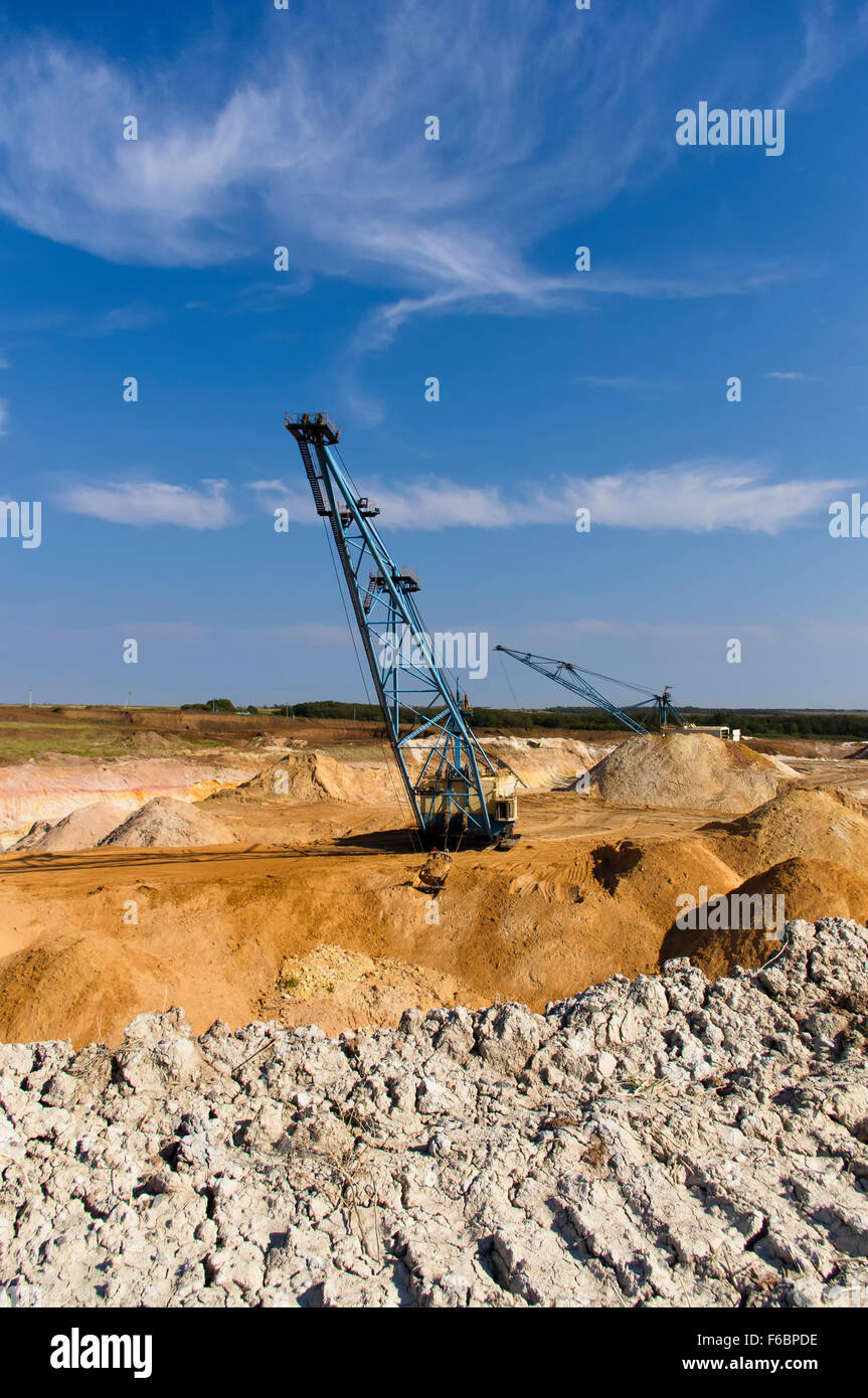 the big dipper dragline excavator digging clay on blue sky background ...