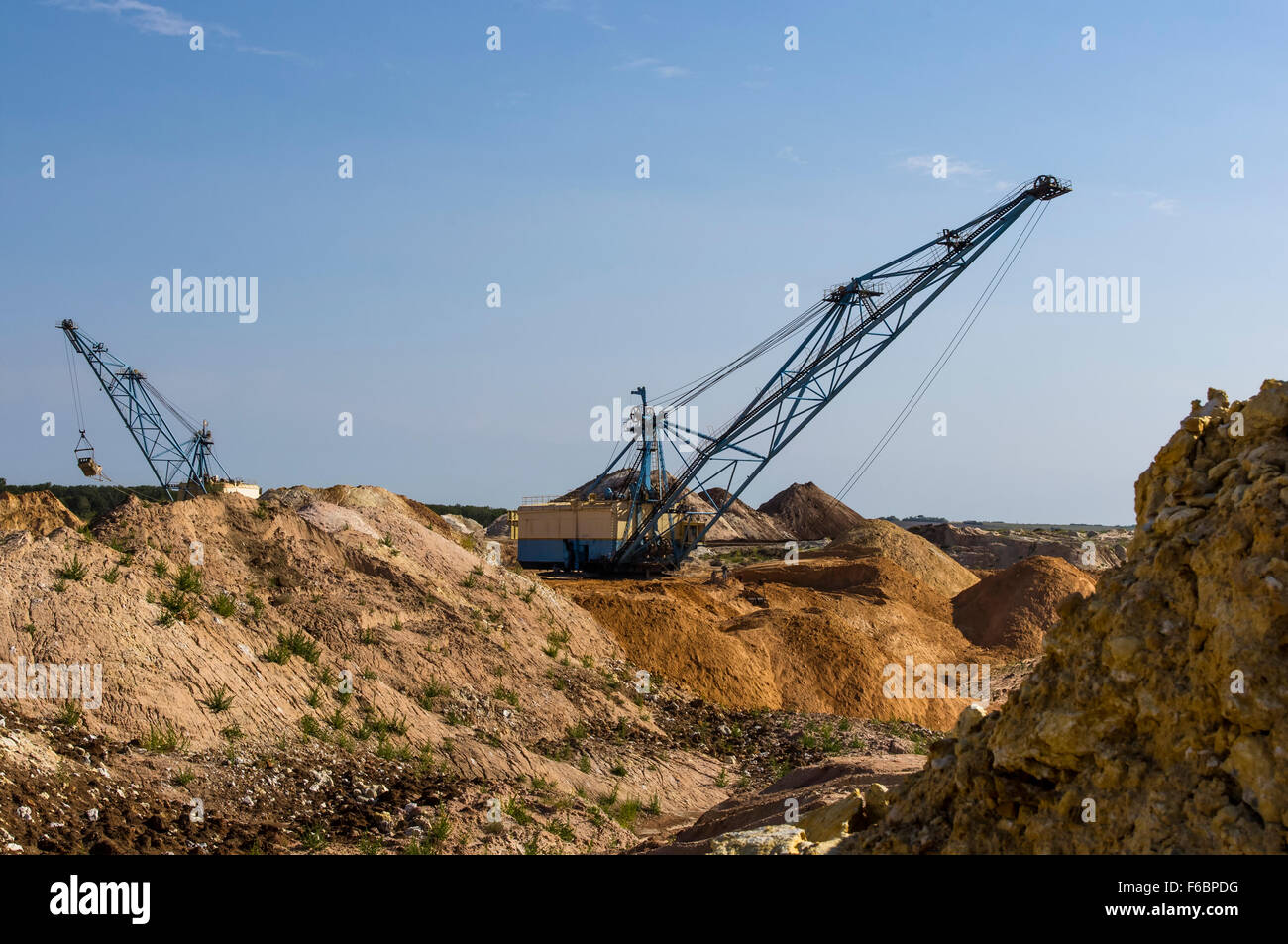 the big dipper dragline excavator digging clay on blue sky background ...