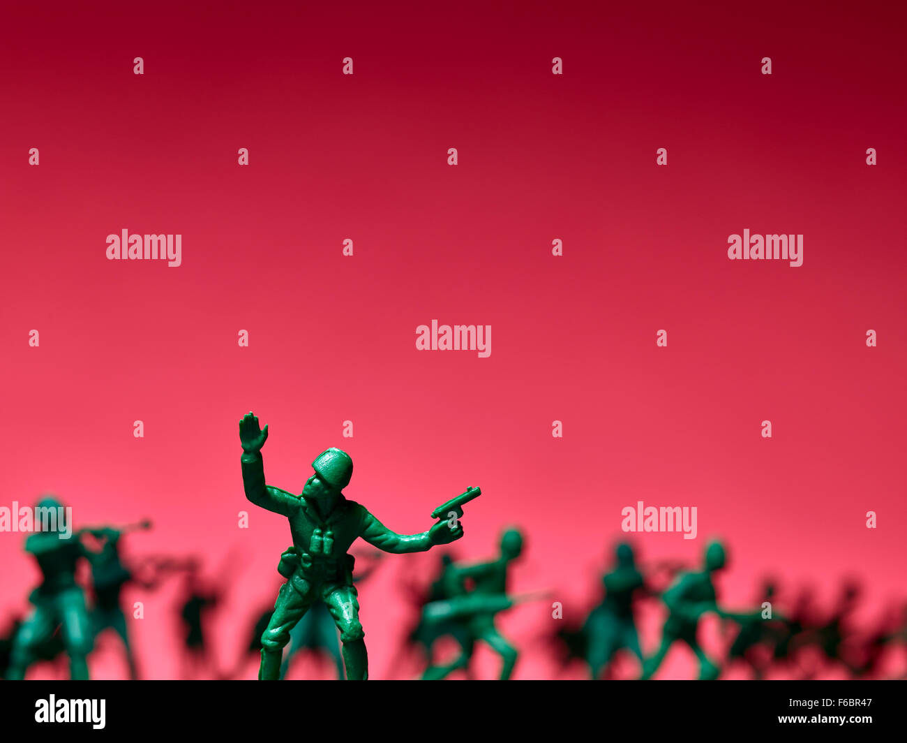 Plastic soldier and team, red background Stock Photo - Alamy