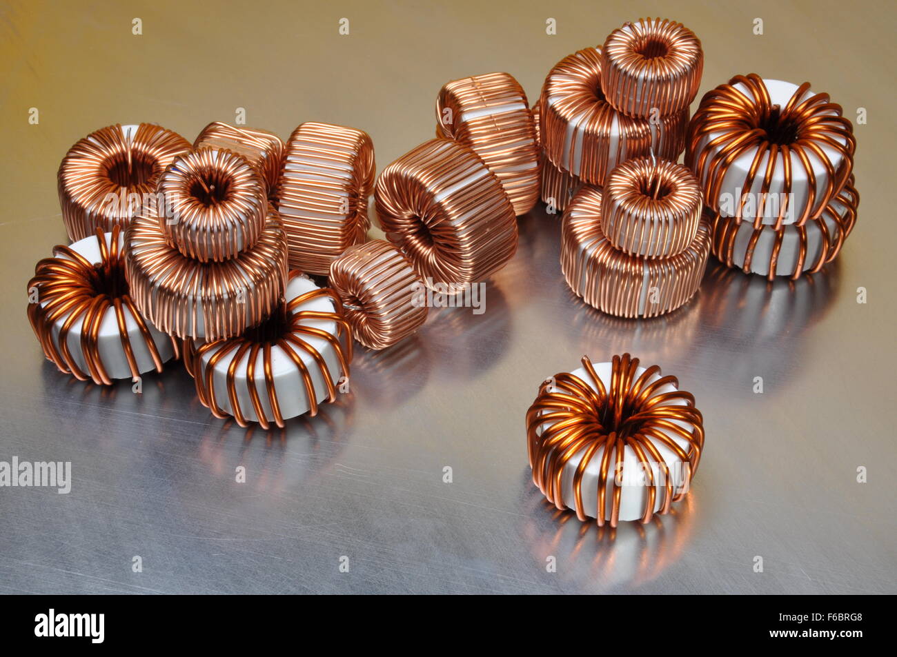 Electric copper coils on metal background Stock Photo - Alamy