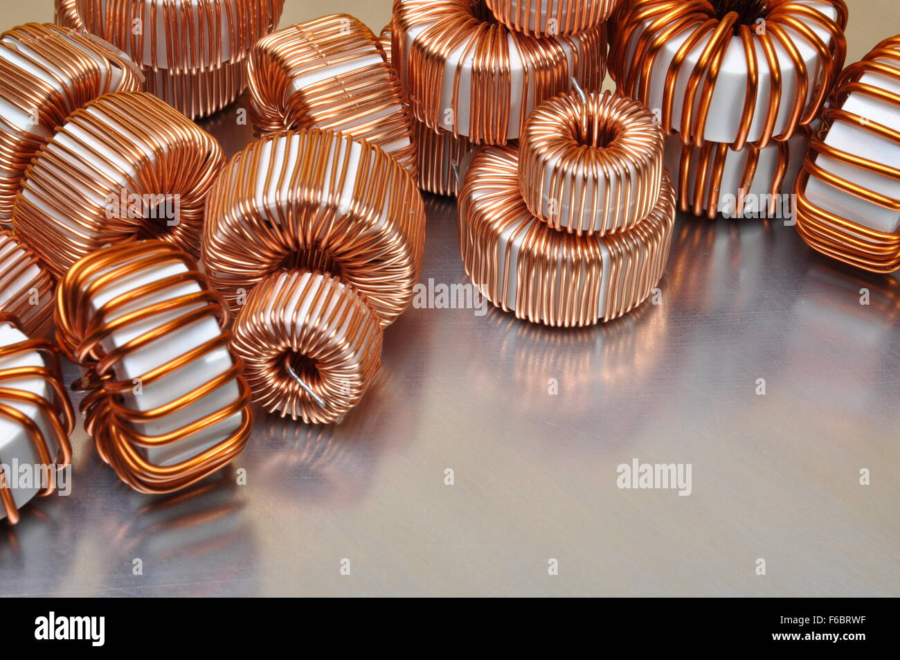 Electric copper coils on metal background Stock Photo - Alamy
