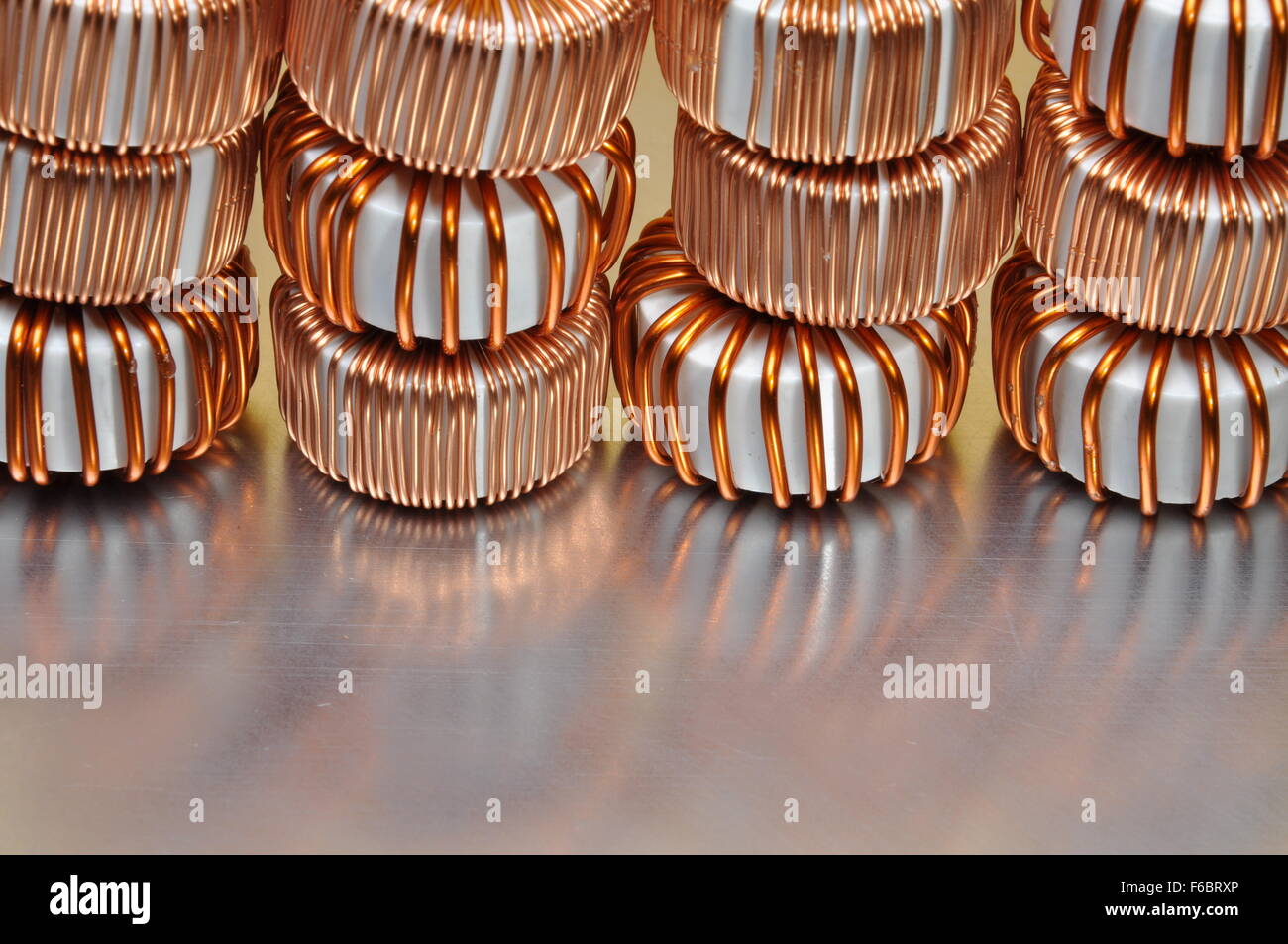 Electric copper coils on metal background Stock Photo - Alamy