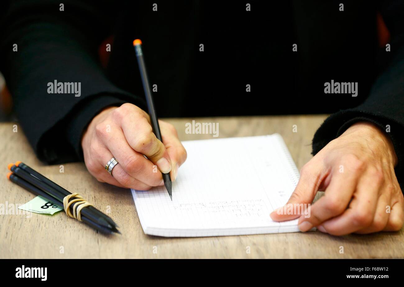 A journalist uses a pencil provided by court officials after ballpoint ...