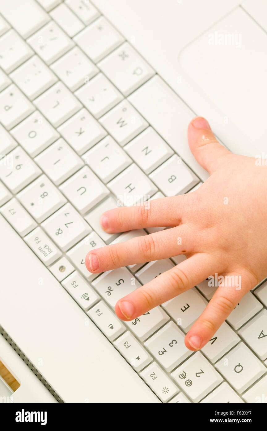 A childs hand on a computer or lap top keyboard Stock Photo - Alamy