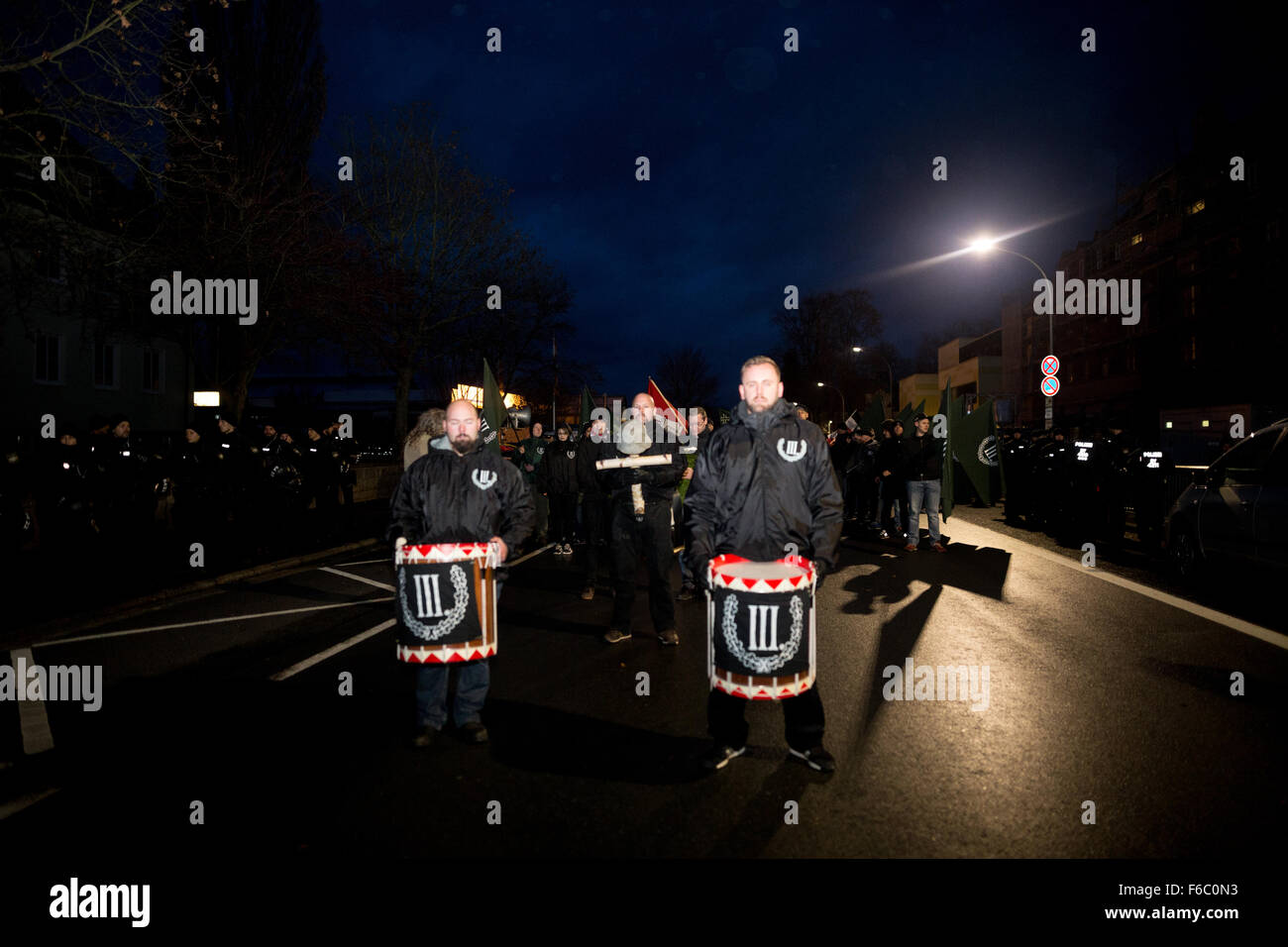 Neonazis line up, enlight torches and play music, to walk thorugh ...