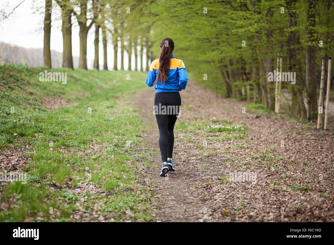 Young beautiful woman running on a trail Stock Photo - Alamy