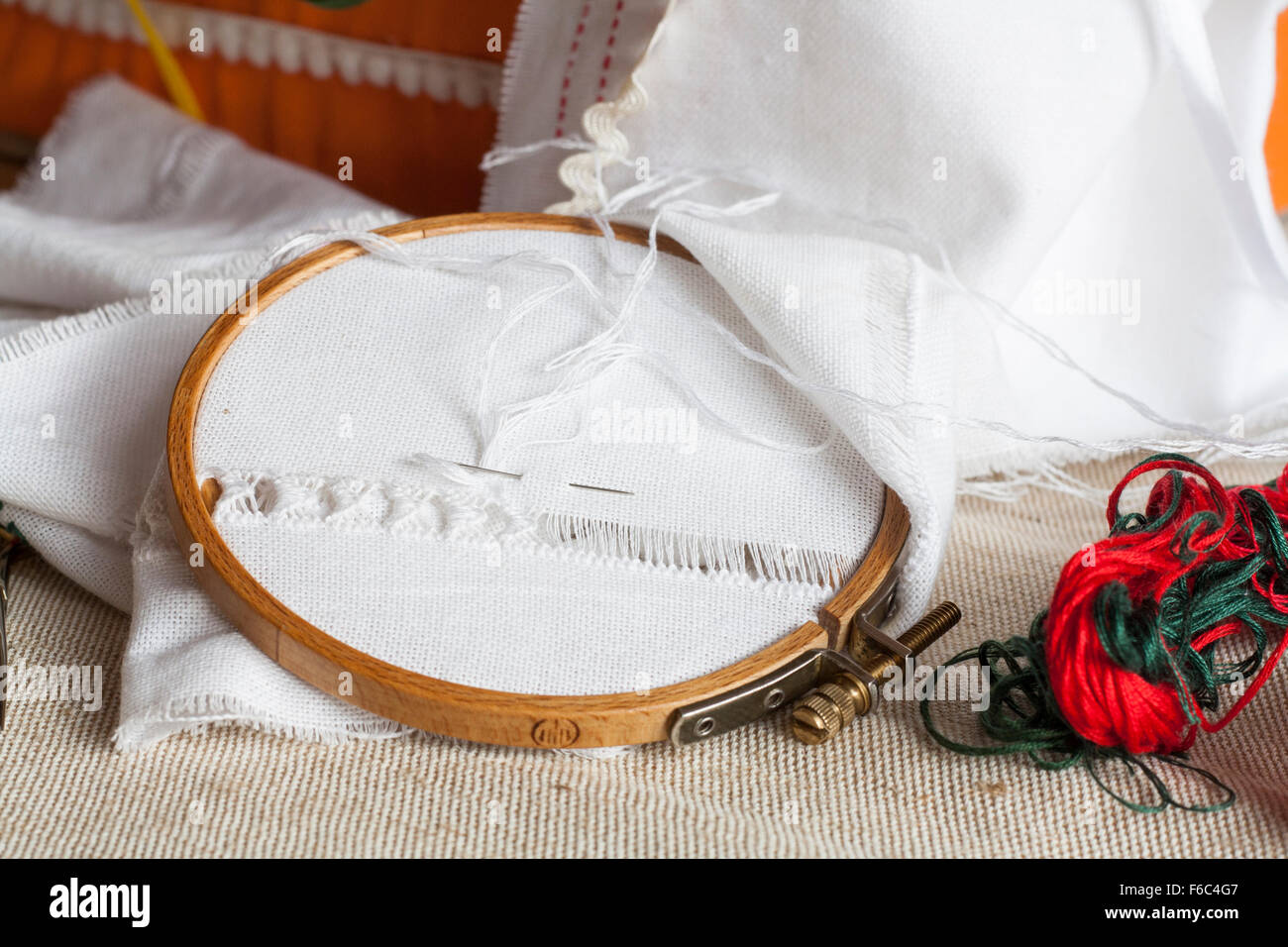 Openwork embroidery, incomplete work in progress and tools for ...