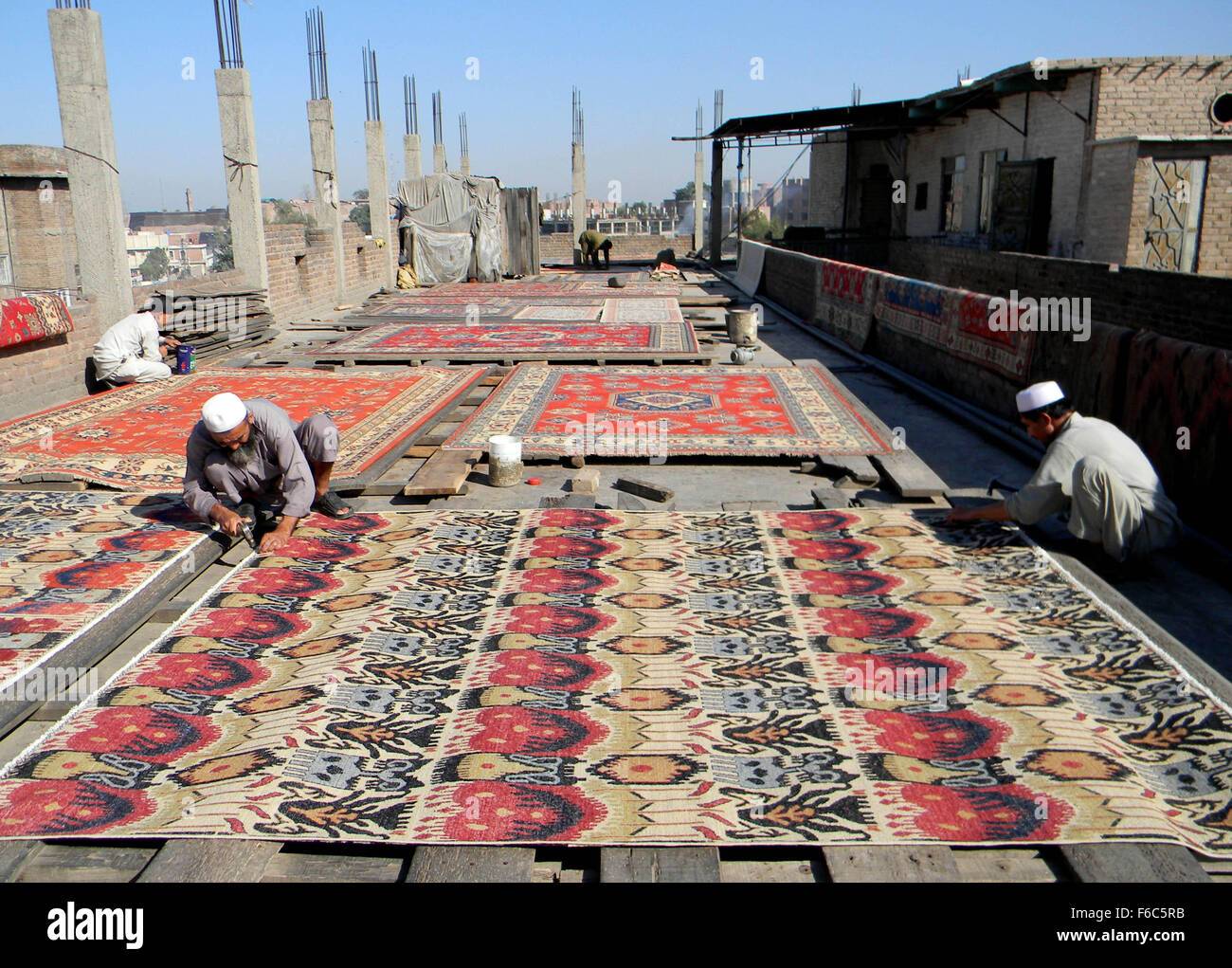 Peshawar. 16th Nov, 2015. Pakistani men make handmade carpets at a ...