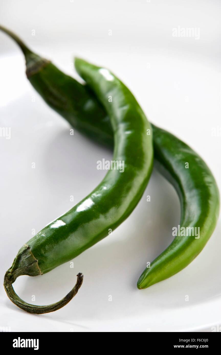 Two green chilli peppers Stock Photo - Alamy