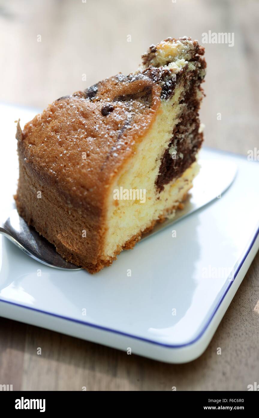 A slice of marble cake on a cake slice Stock Photo - Alamy