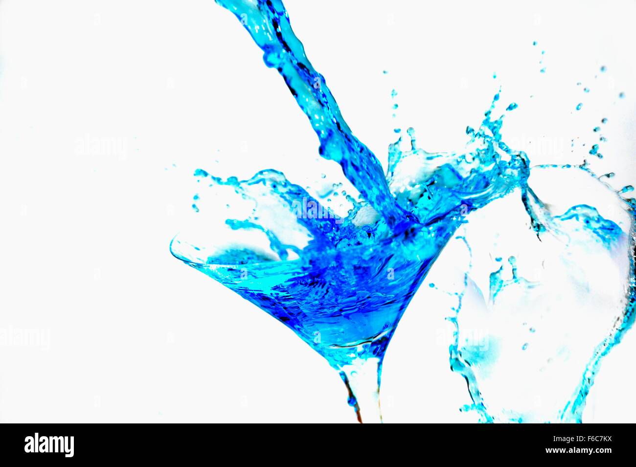 Pouring a blue cocktail into a martini glass Stock Photo - Alamy