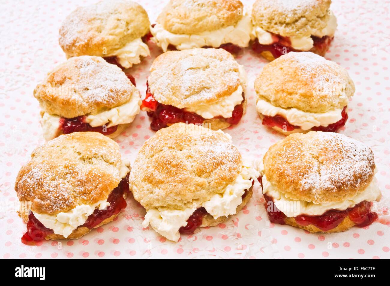 Nine scones with raspberry jam and cream Stock Photo - Alamy