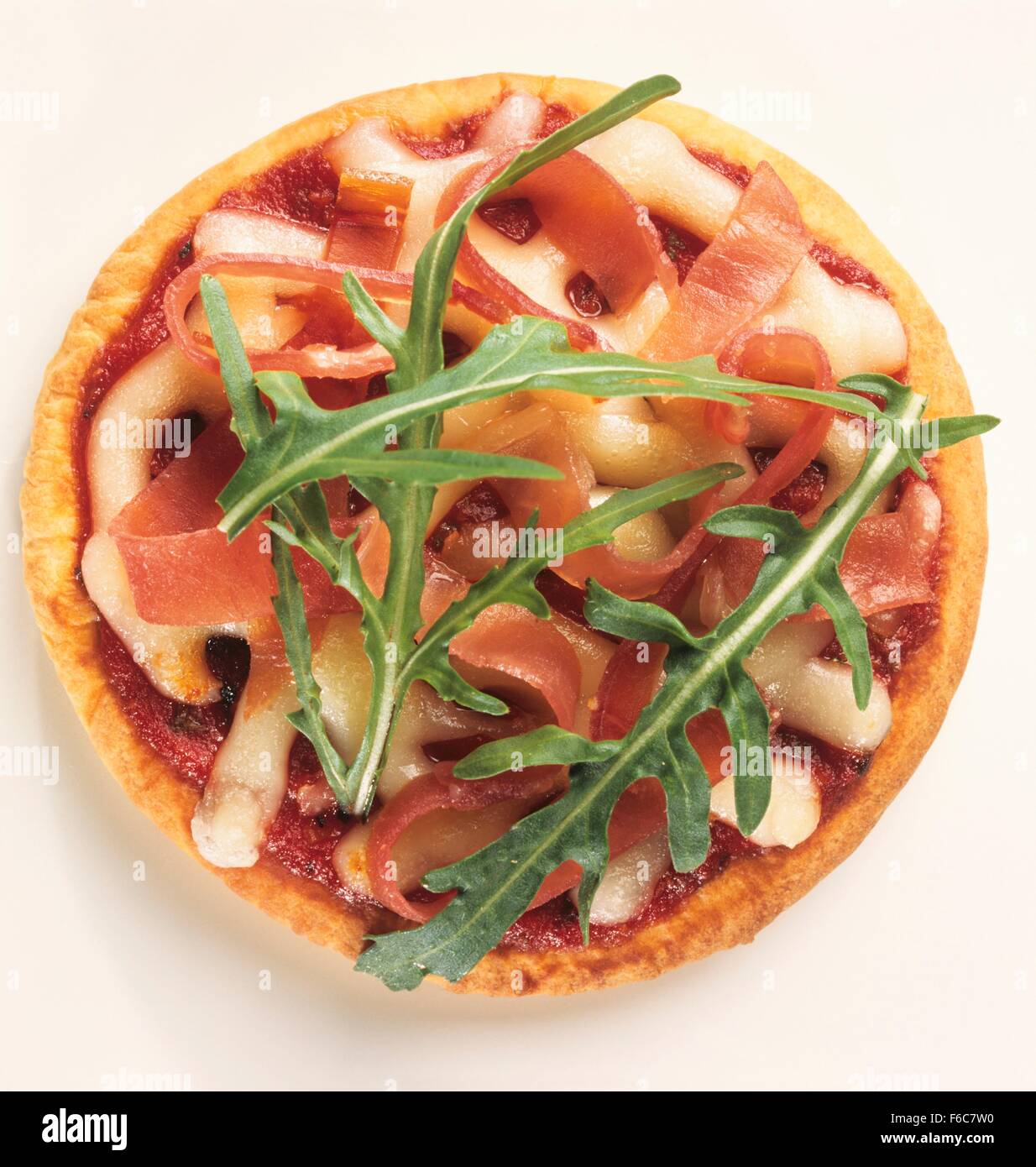 A small ham and mozzarella pizza with rocket Stock Photo - Alamy