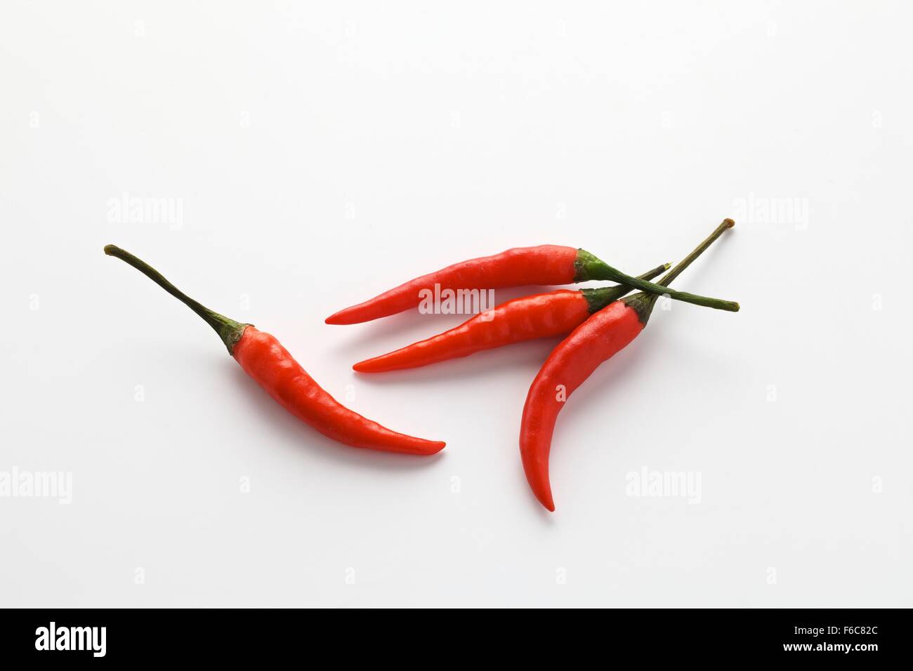 Four red chillies Stock Photo - Alamy