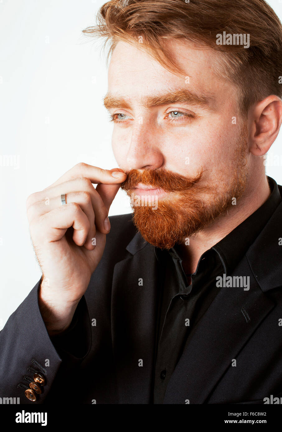 young red hair man with beard and mustache in black suit on white ...