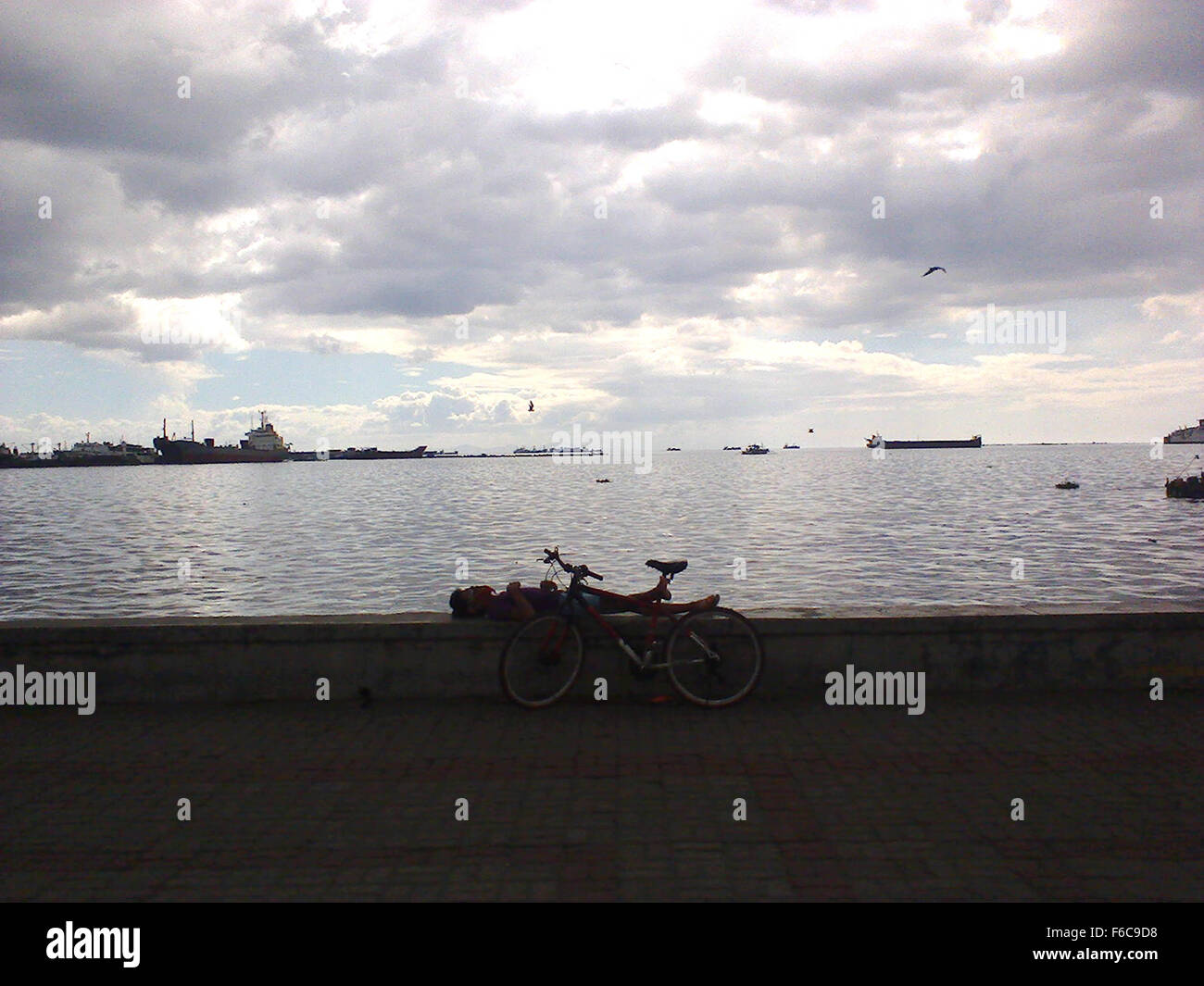 A Filipino sleeps along the coast of Manila Bay in Navotas City, north ...