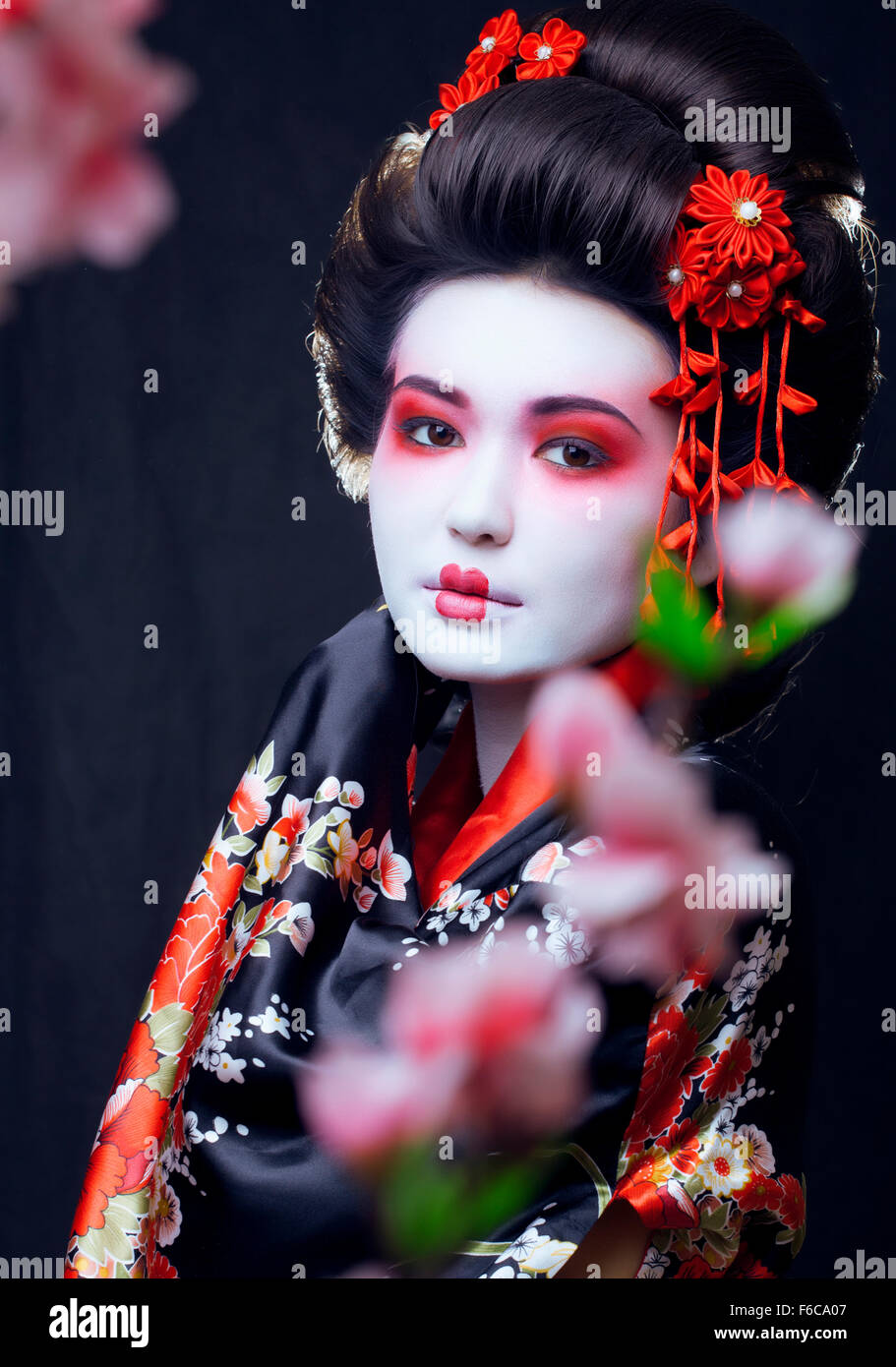 young pretty geisha in kimono with sakura and decoration Stock Photo ...
