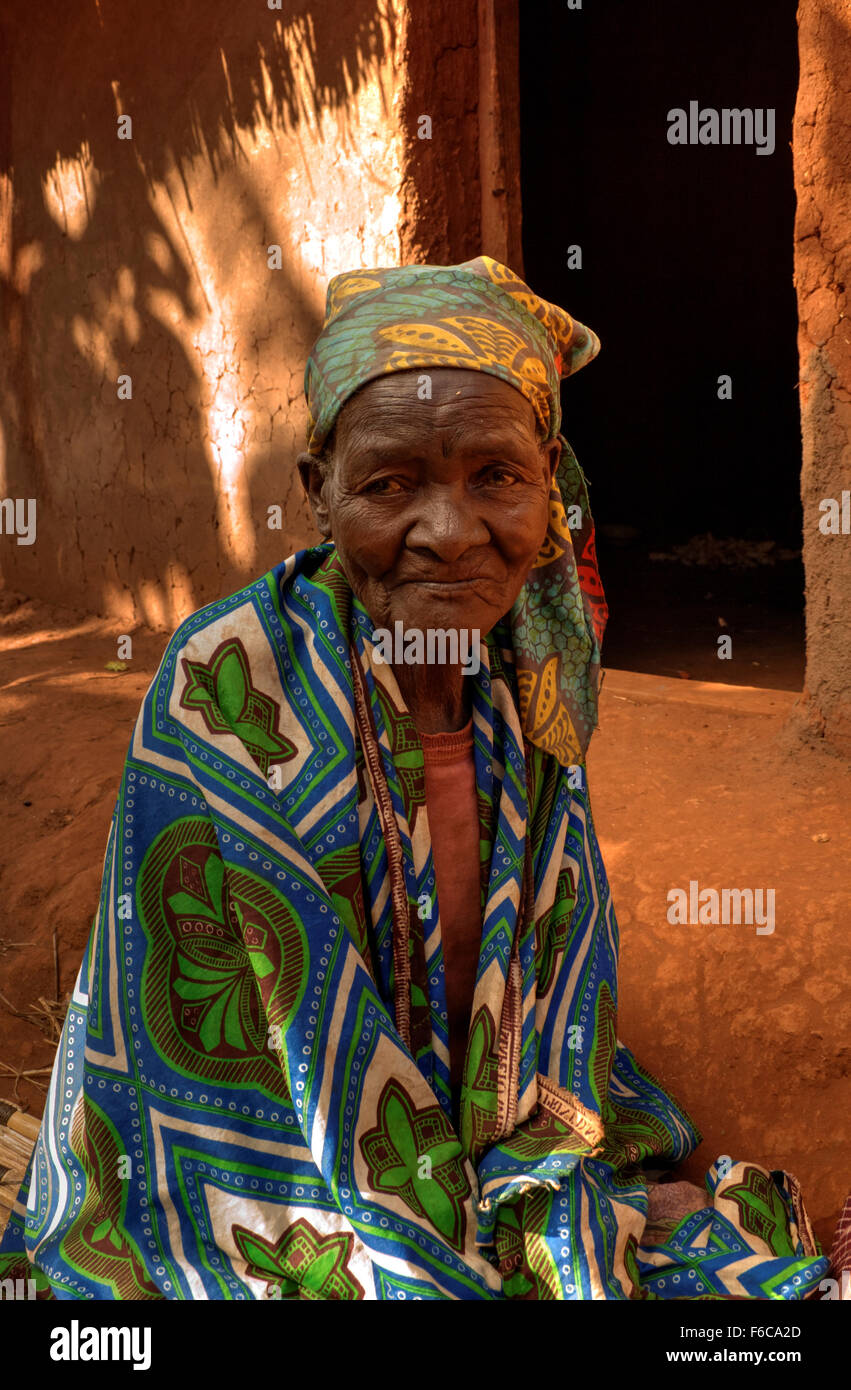 A portrait of an old black woman wearing a chitenje over her shoulders ...
