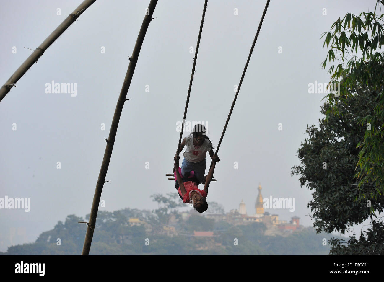 Nepalese kids playing on a swing during their leisure time as ...