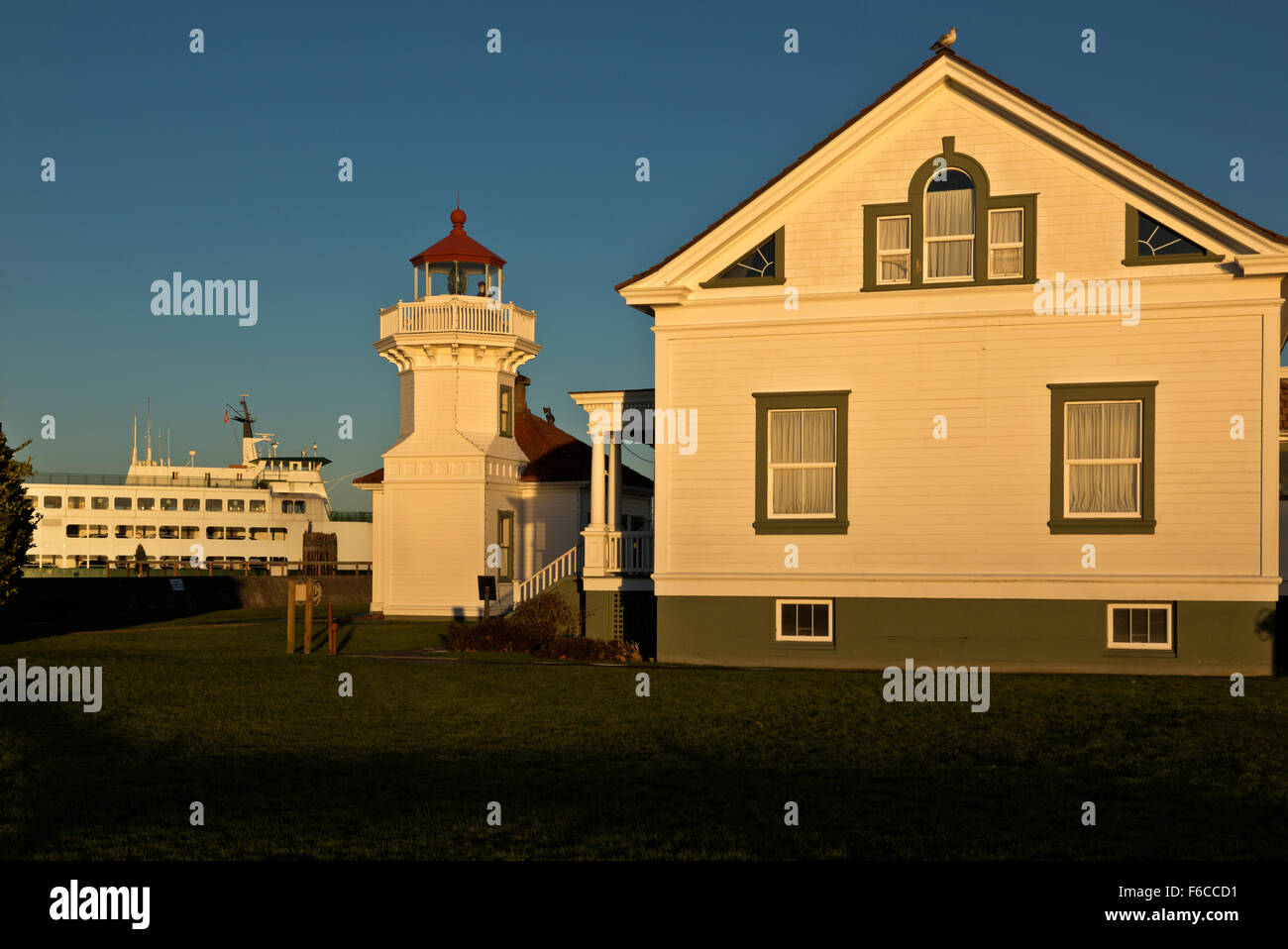 WASHINGTON - Sunset color turning the Mukilteo Light Station a deep ...