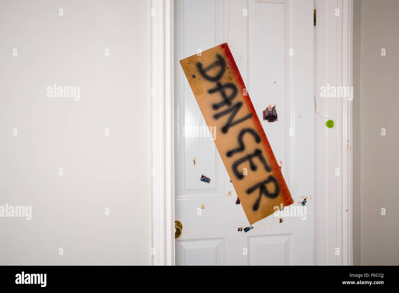 A warning sign on a door in a house saying Danger Stock Photo - Alamy