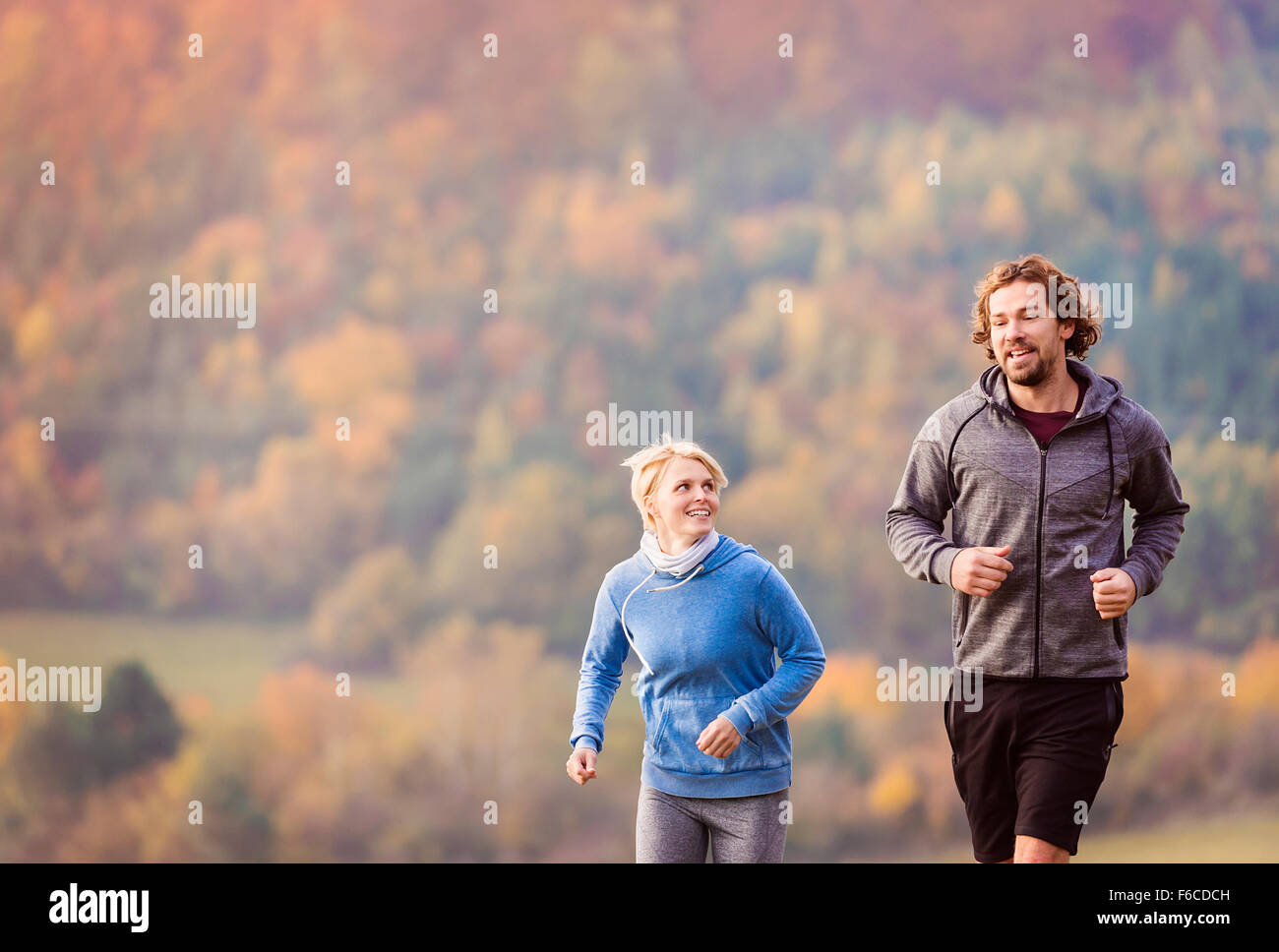 Beautiful couple running Stock Photo - Alamy