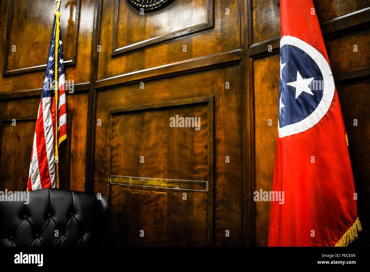 Interior of small town TN court room with wooden walls flags and judge ...