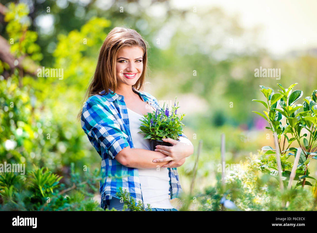 Beautiful young woman gardening Stock Photo - Alamy