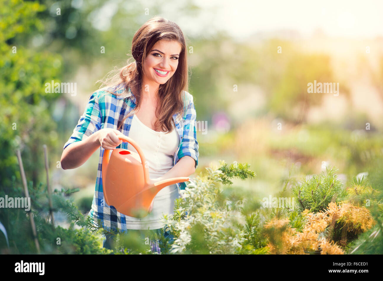 Beautiful young woman gardening Stock Photo - Alamy