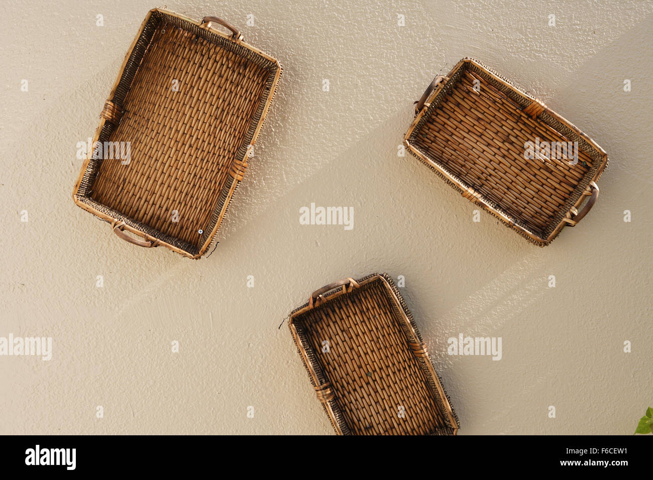 Three baskets hanging on the wall Stock Photo - Alamy