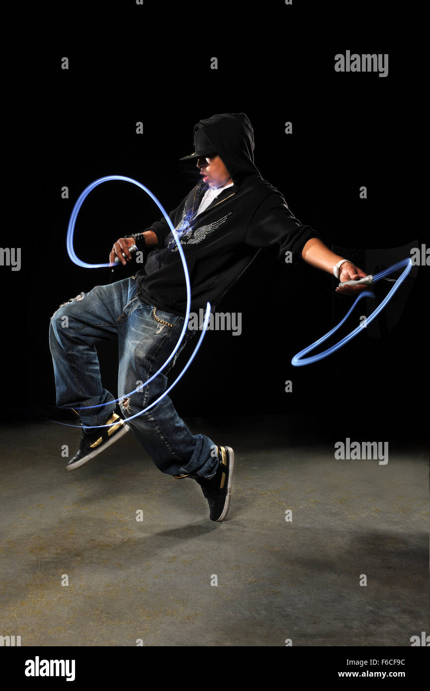 African American hip hop dancer with LED lights over dark background ...