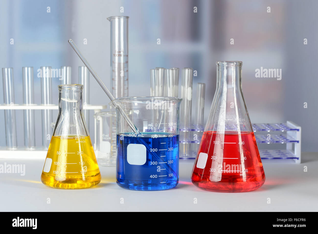 Laboratory glassware with colored liquids on lab table Stock Photo - Alamy