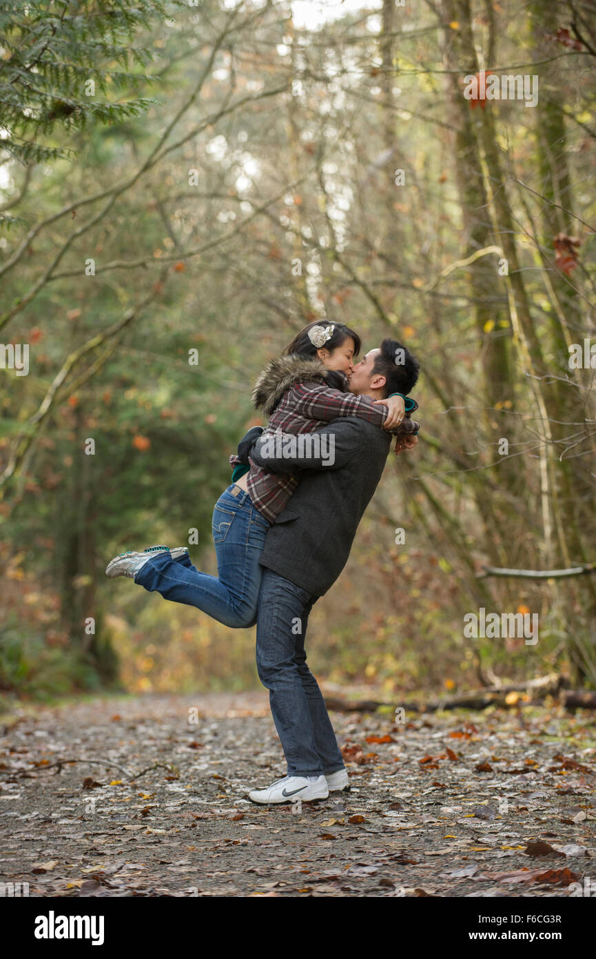 Man picking up woman Stock Photo - Alamy