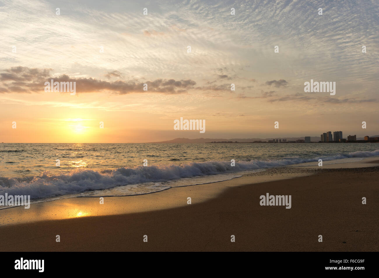 Beach city sunset is an image of a wave rolling to shore and city ...