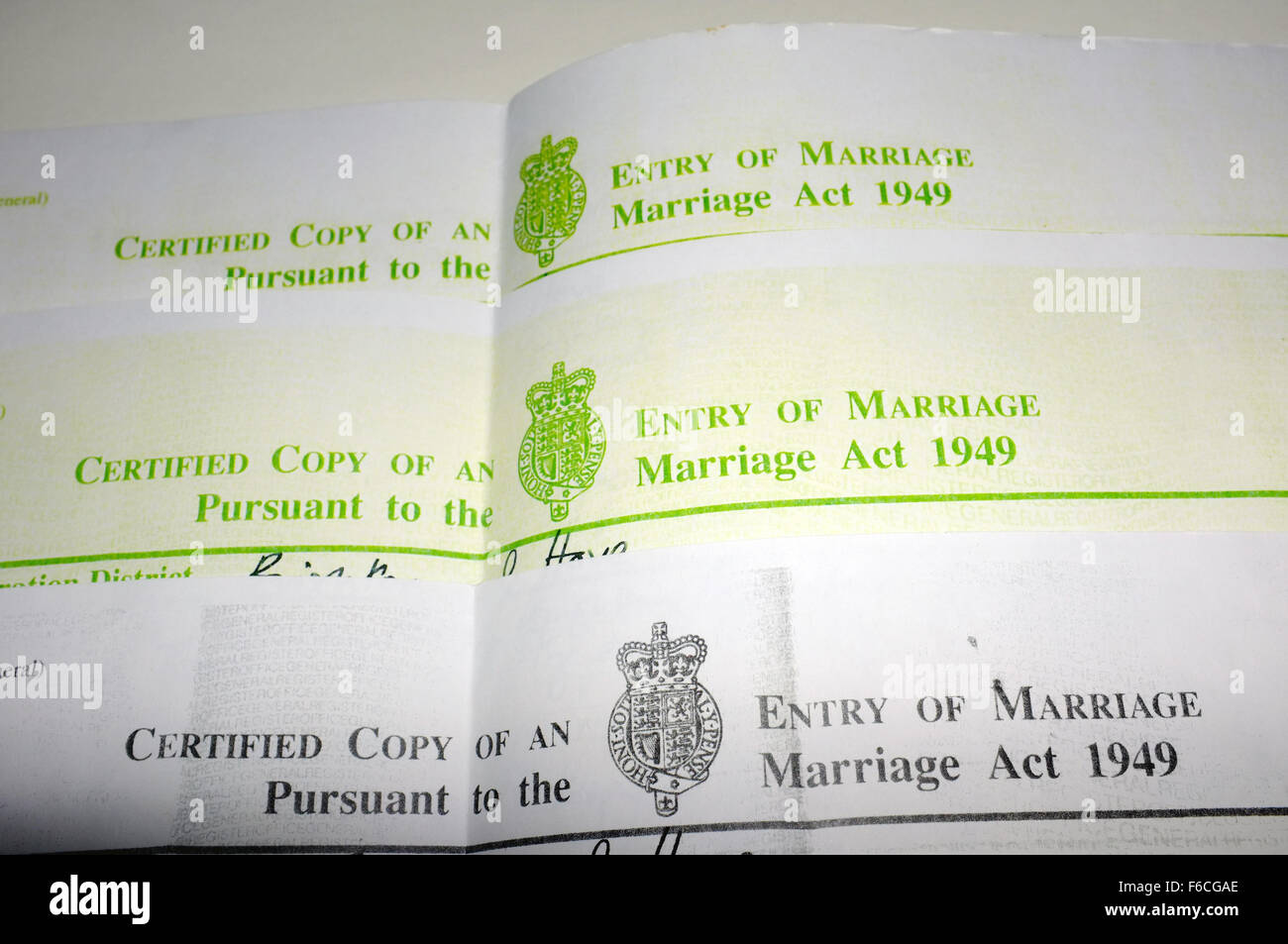 A British Marriage certificate with two photocopies photographed ...